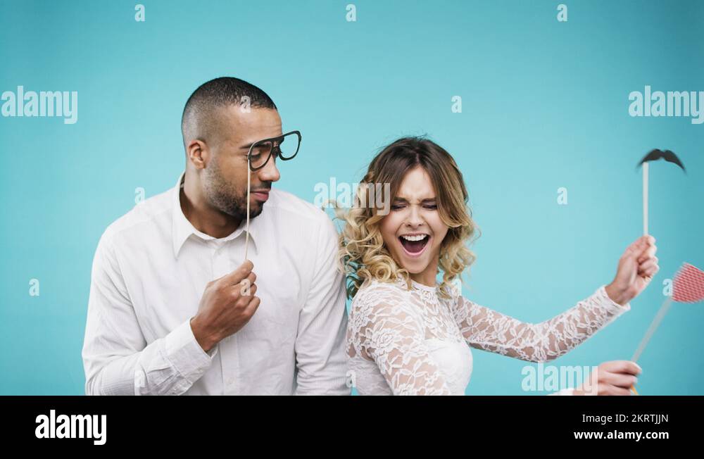 Attractive mixed race couple dancing slow motion party photo booth ...