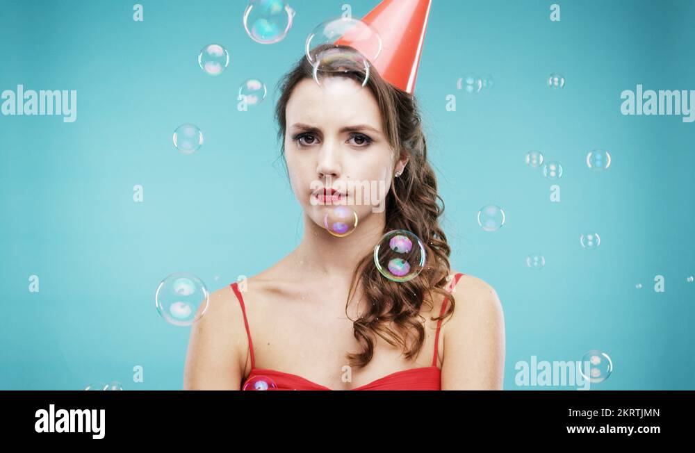 Single woman is sad in bubble shower slow motion photo booth blue ...