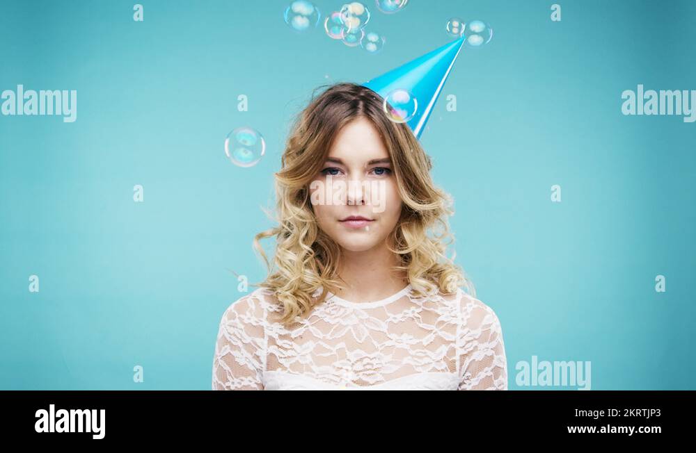 Single woman blue hat is sad in bubble shower slow motion photo booth ...