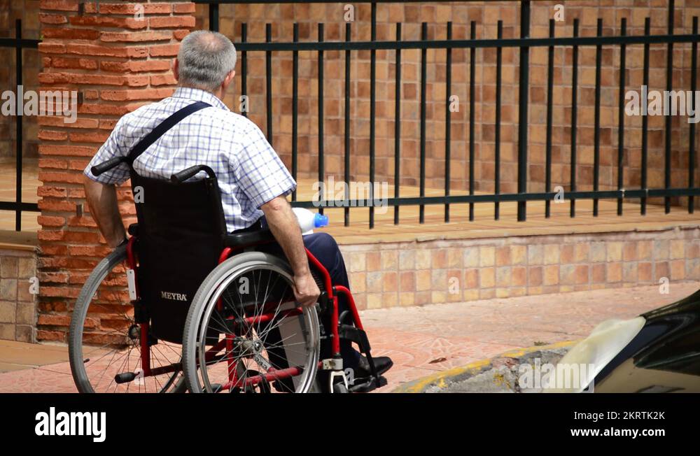 Paraplegic or quadriplegic man in wheelchair Stock Video Footage - Alamy