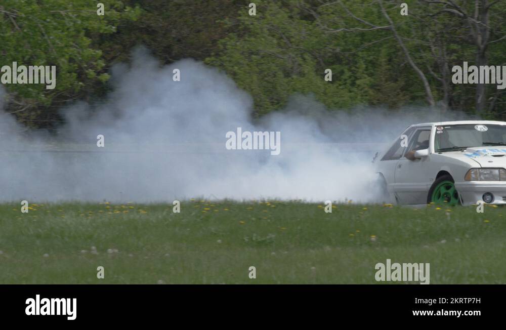 Stunt driver drifting on a road - aggressive turn into the corner with ...