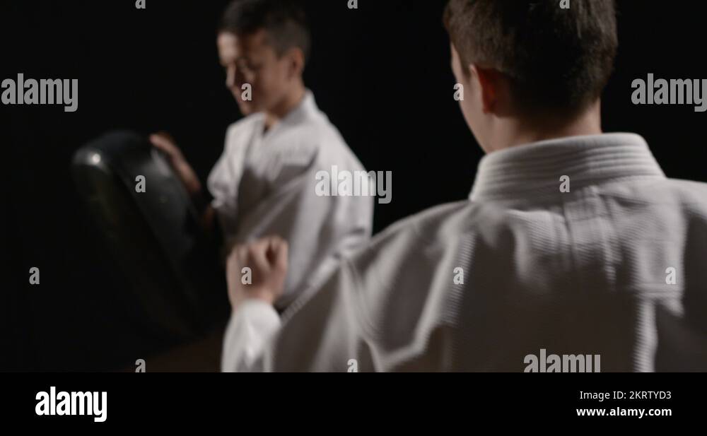 Karate kid kicking on bag focus pull Stock Video Footage - Alamy