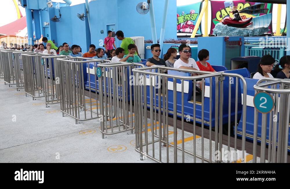 People sit in the booth ride a roller coaster in the Ocean Park Hong ...