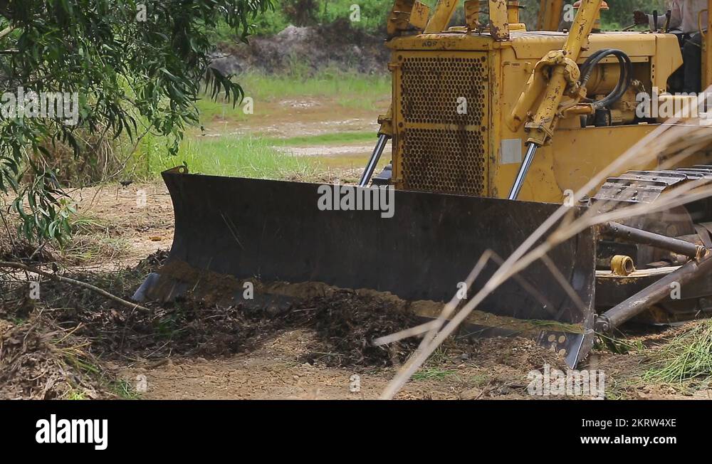 Unidentified worker control Bulldozer to excavator grader removing the ...