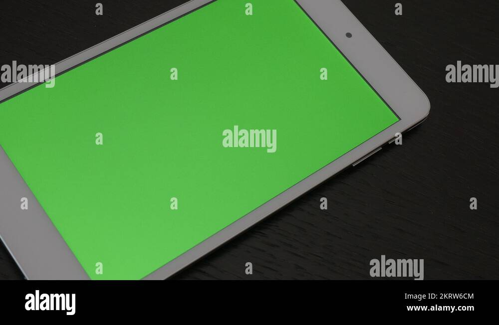 Green screen chroma display on silver PC tablet slow panning 4K ...
