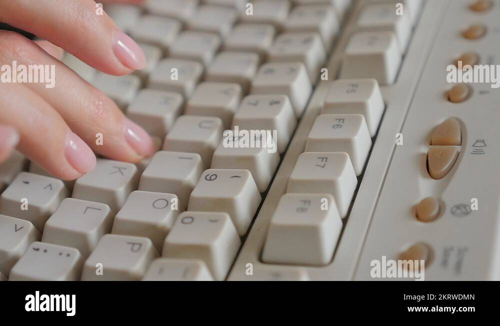 Female typing on aged white PC keyboard slow motio 4K 3840X2160 UHD ...