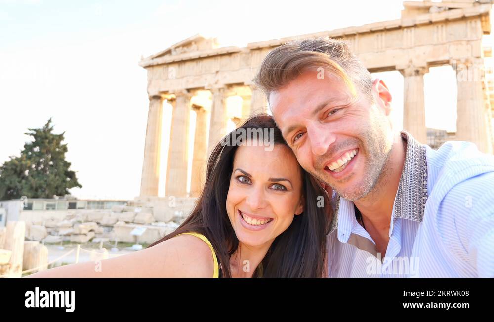 Beautiful Greek couple takes a selfie with Greek architecture in the ...