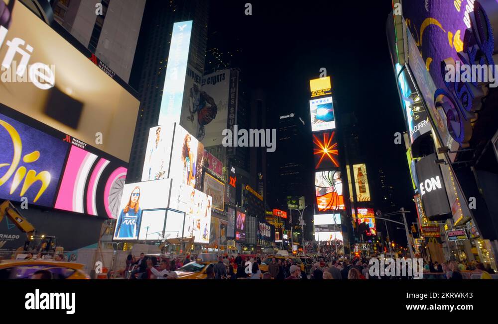 Commercial billboards and crowd on Times Square New York City at night ...