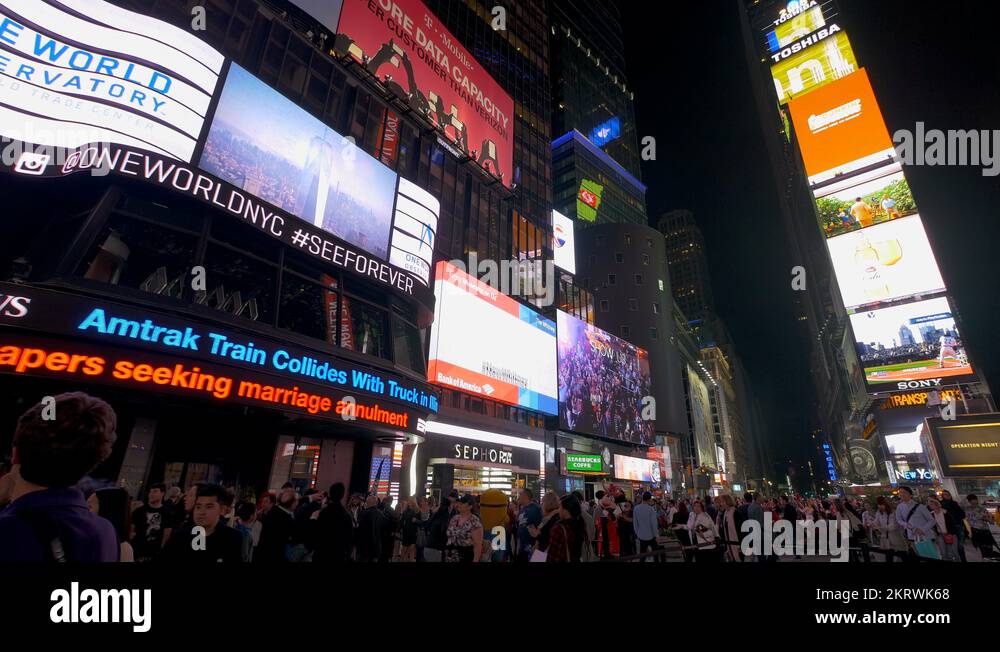 Commercial billboards and crowd on Times Square New York City at night ...
