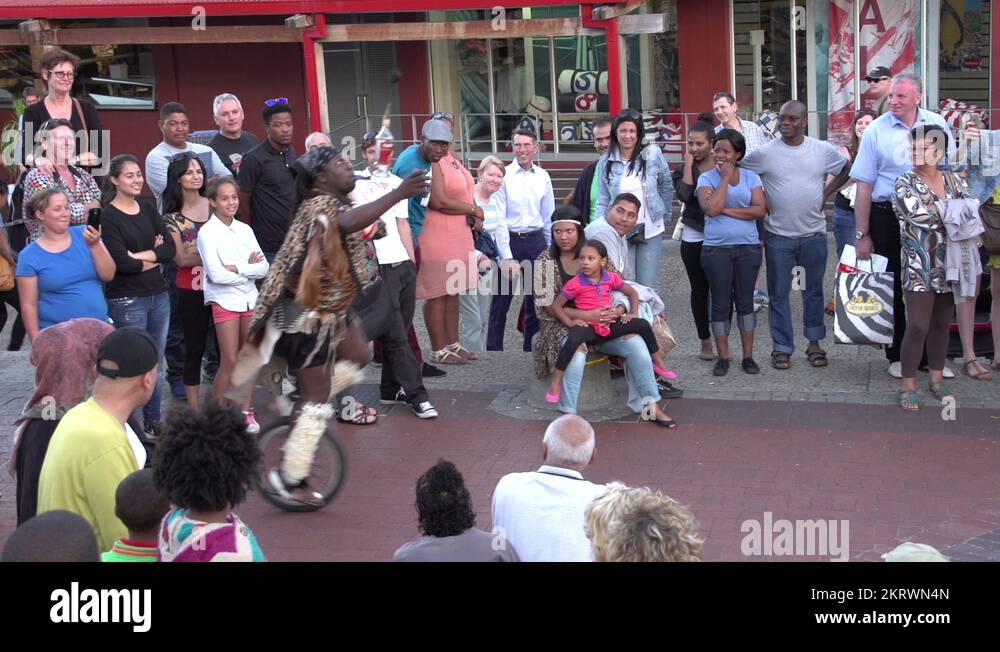 Busker performing in front of a crowd of people at Victoria and Alfred ...