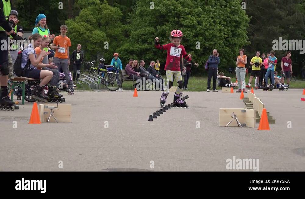 zoom out small girl ride slowly with roller skate around cone. 4K Stock ...