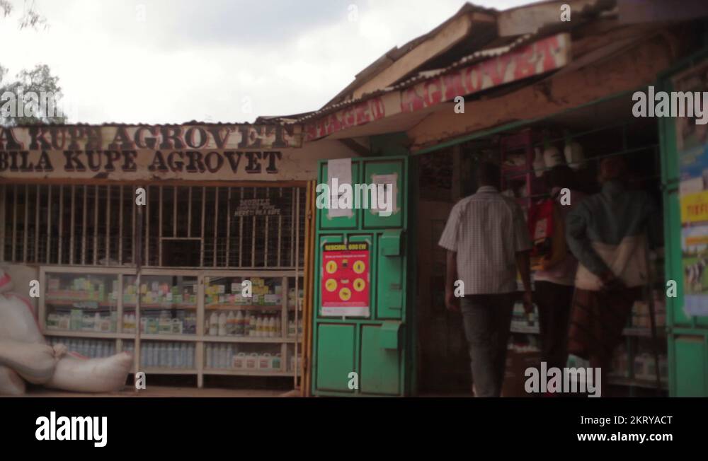 People outside a grocery shop in rural town of Maralal, Kenya, Africa ...