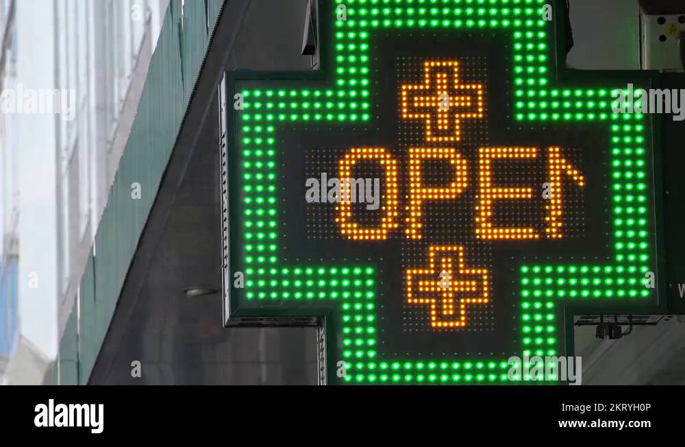 4K Pharmacy sign green light open medical care landmark symbol medicine ...