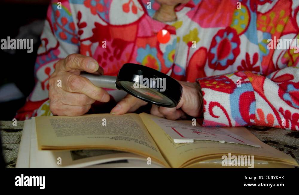 Very Old Lady Reading A Book With A Magnifying Glass, Poor Vision, Tilt ...