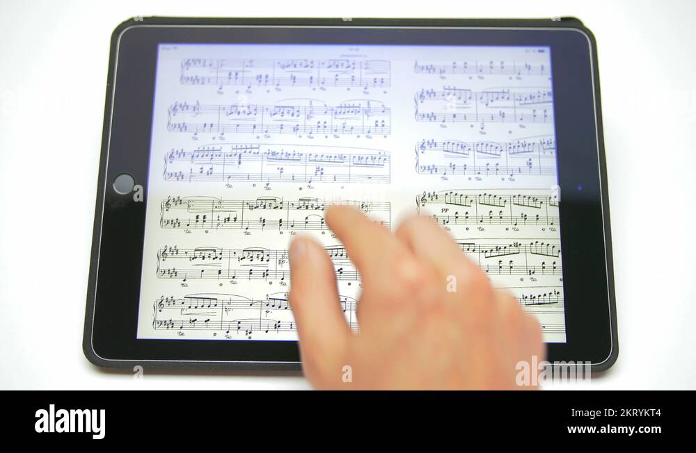 The hand (finger) work with music notes on the touchscreen by white ...