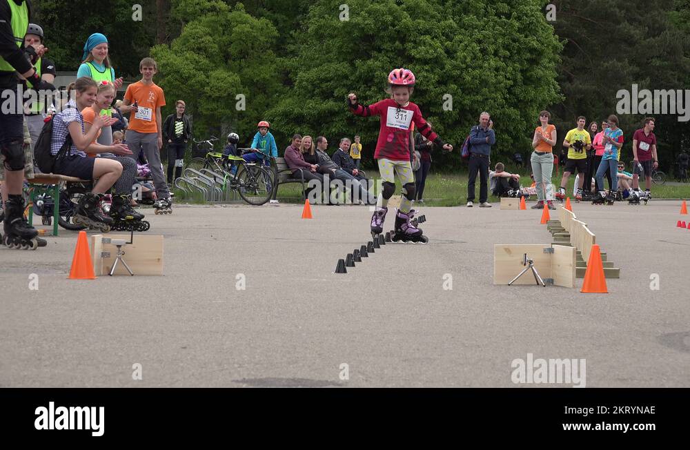 zoom out small girl ride slowly with roller skate around cone. 4K Stock ...