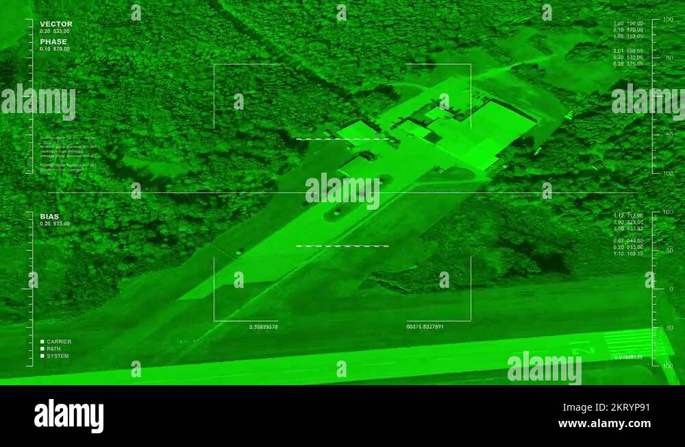 Night vision aerial surveillance flyover of a small airport's hangar ...