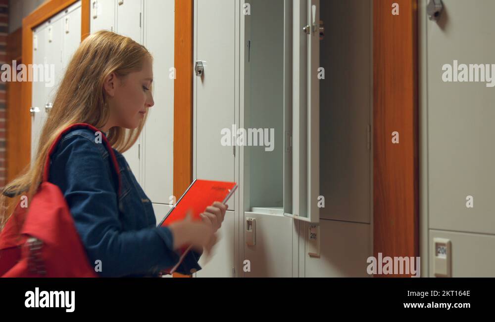 Student gathering her school books from a locker Stock Video Footage ...