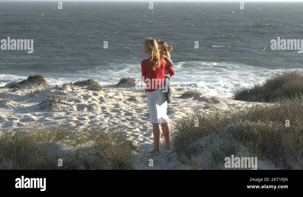 LS OF A MOTHER AND DAUGHTER STANDING ON A BEACH Stock Video Footage - Alamy