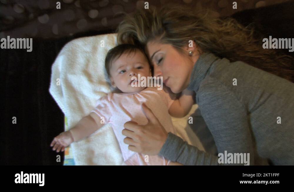 MCU ZI OF A MOTHER KISSING HER BABY ON THE CHEEK Stock Video Footage ...