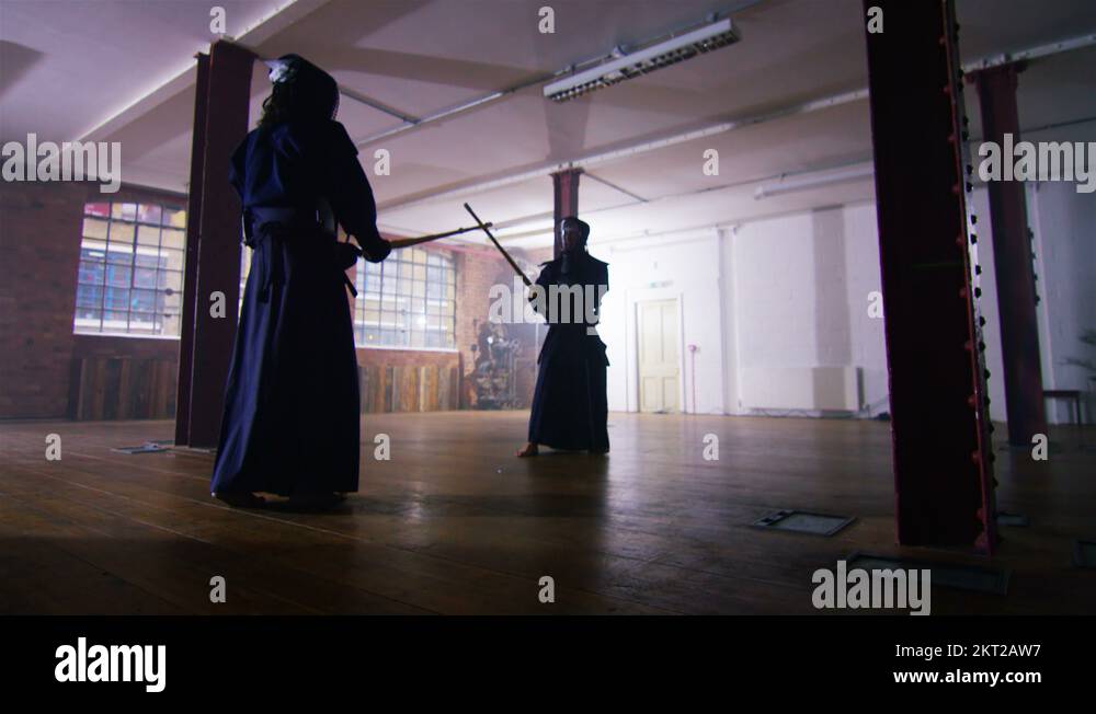 4K Japanese kendo fighters with bamboo swords competing in dark ...