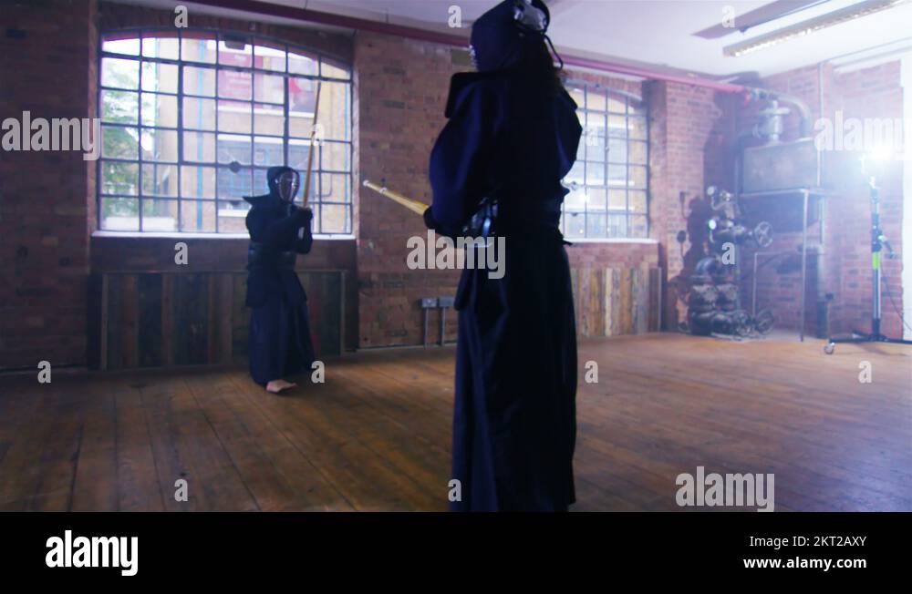 4K Japanese kendo fighters with bamboo swords competing in dark ...