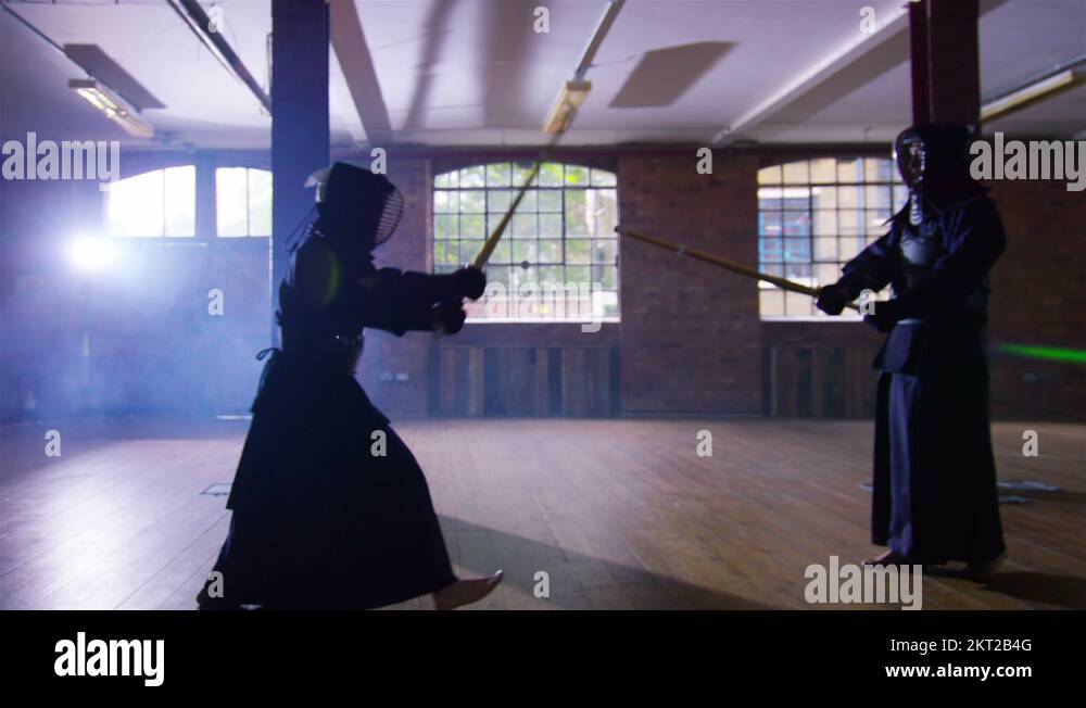 4K Japanese kendo fighters with bamboo swords competing in dark ...
