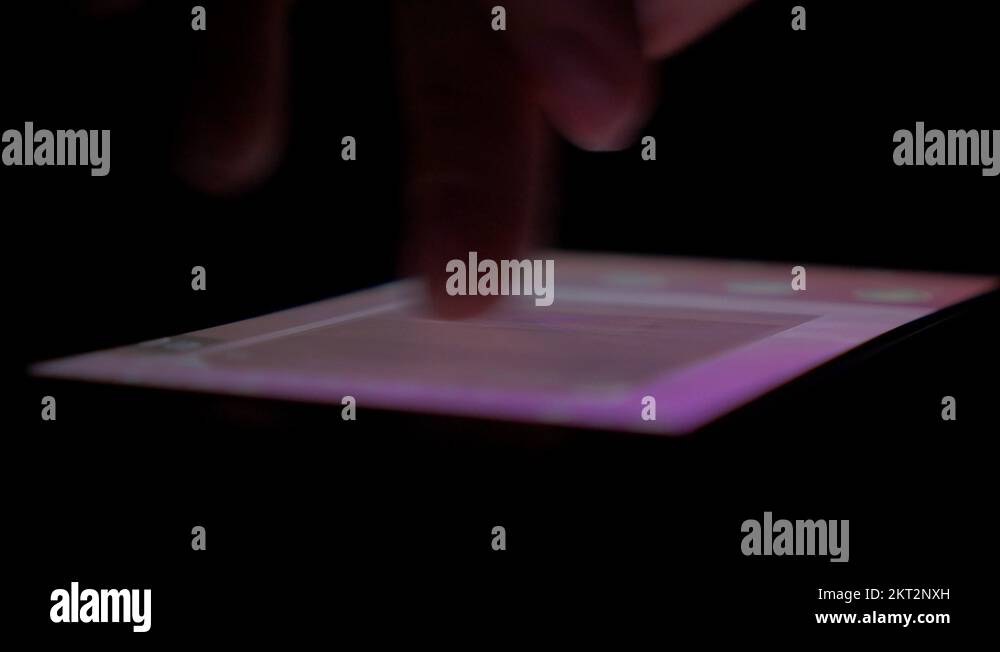 Scrolling through smart phone menu pages in dark 4K 3840X2160 UHD video ...