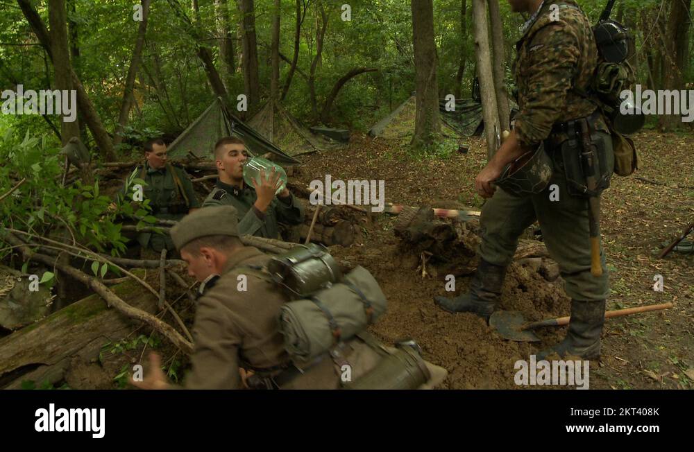WWII German soldiers drink water in foxhole Stock Video Footage - Alamy