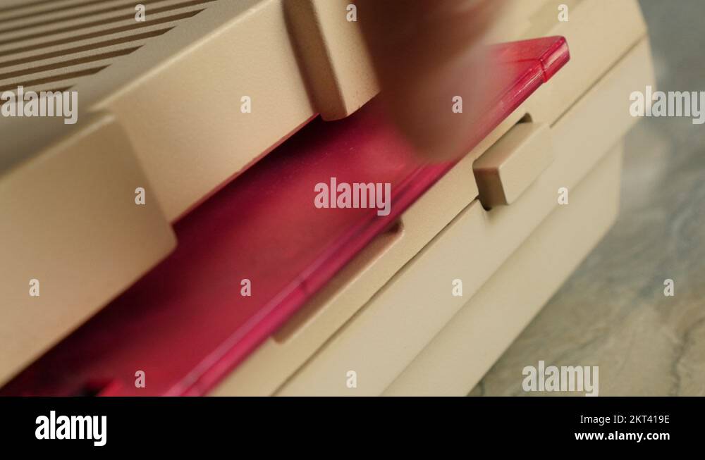 Insert ancient 3.5 inch floppy disk in retro personal computer 4K 2160p ...