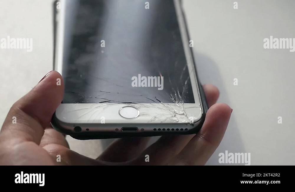 Women hand uses smartphone with badly broken screen in slowmotion Stock ...