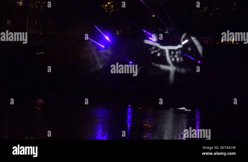 laser light reflection on water and on river shore at night. 4K Stock ...