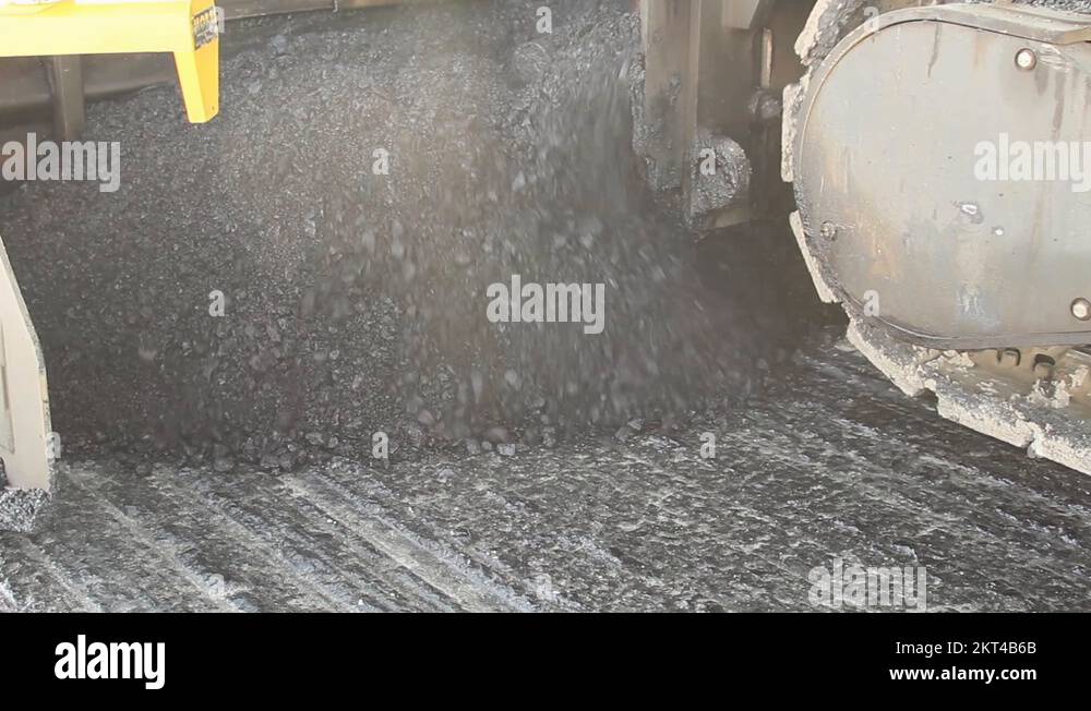 Tracked paver laying fresh asphalt pavement Stock Video Footage - Alamy