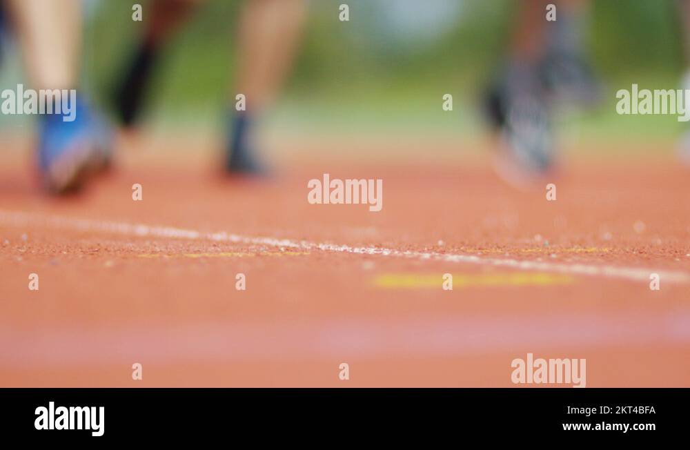 4K Low angle view, the feet of unrecognisable runners on a running ...