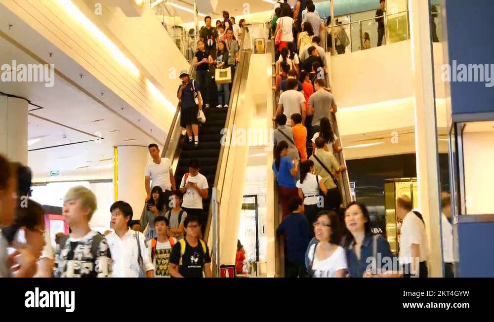 Escalator 4k shopping mall crowd of people buy shop center centre money Stock Video Footage - Alamy