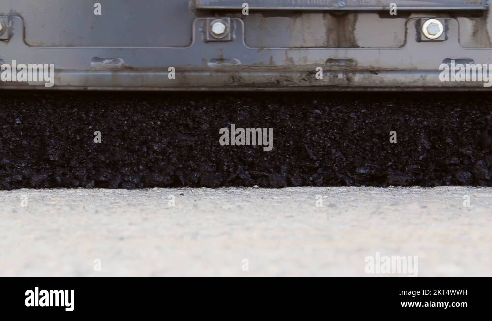 Tracked paver laying fresh asphalt pavement Stock Video Footage - Alamy