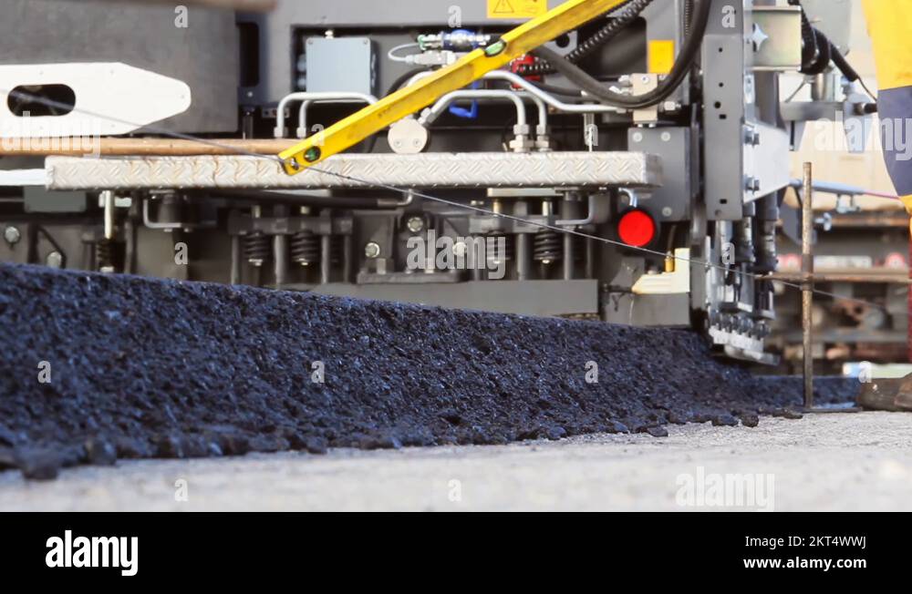 Tracked paver laying fresh asphalt pavement Stock Video Footage - Alamy