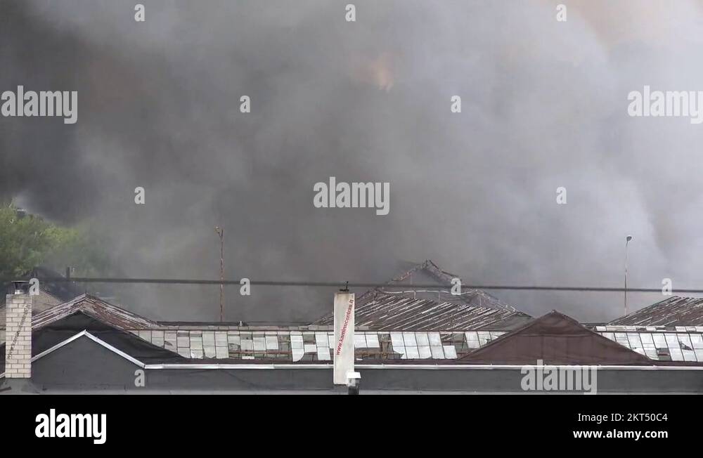 Burning warehouse buildings with black smoke rising from roof. 4K Stock ...