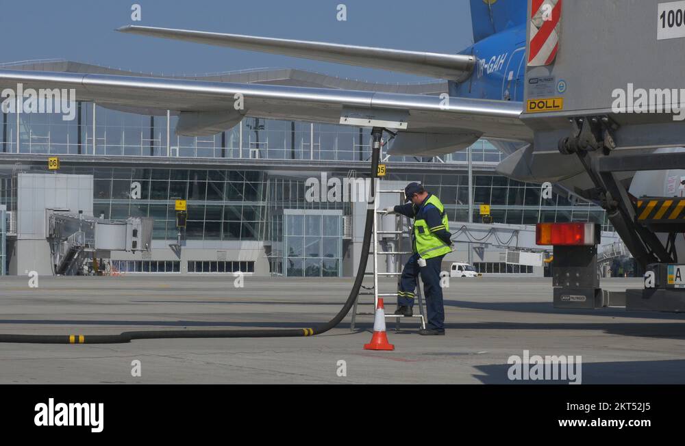 Ground crew member refueling commercial jet Boeing 737-300 before ...
