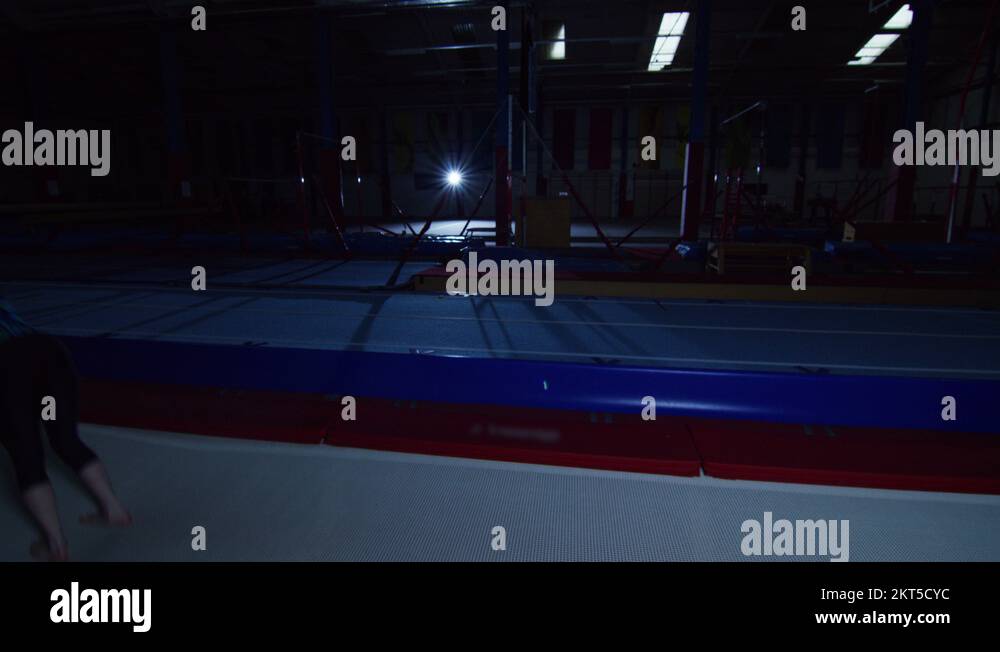 4K Professional female gymnast practicing flips on trampoline Stock ...