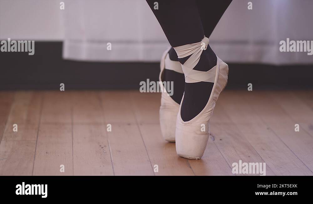 Close up of a ballet dancer's feet as she jumps and changes positions ...