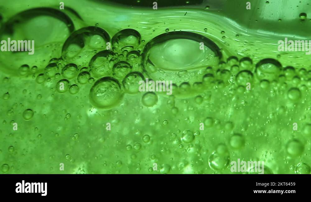 Extreme macro timelapse of bubbles in a green gel - shampoo Stock Video ...