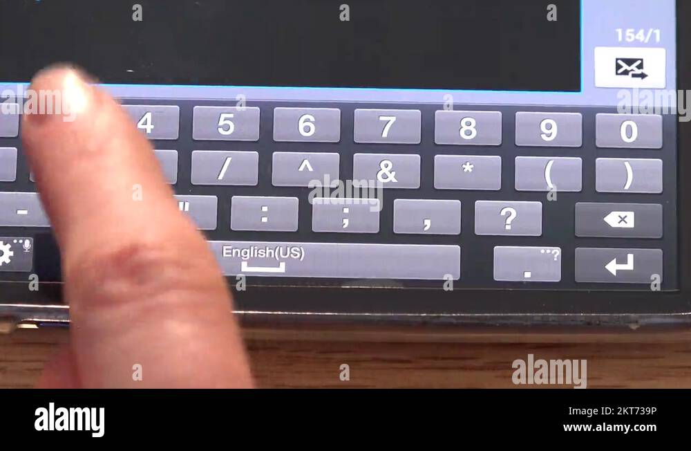 Closeup woman finger touching screen letters and numbers, qwerty ...