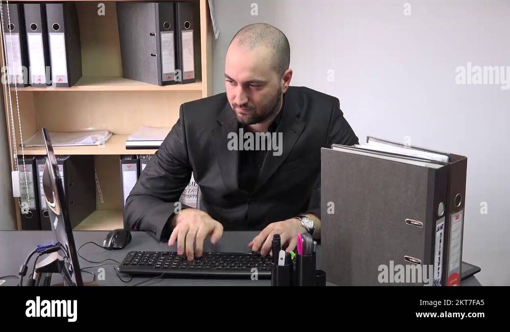 Tired employee inside office neck pain hurt overworked typing keyboard ...