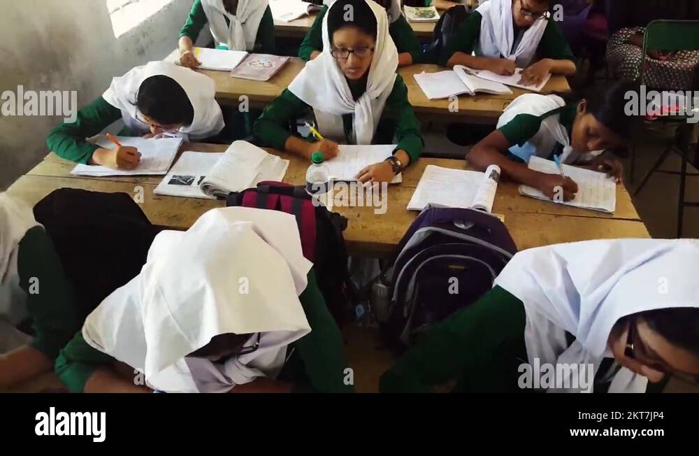 Muslim students with hijab in school studying writing in handbooks ...