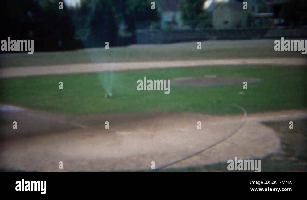 1969: Watering the residential neighborhood baseball field diamond ...