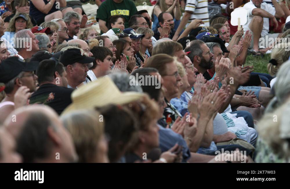 Spectators clapping and cheering at an outdoor entertainment Stock ...