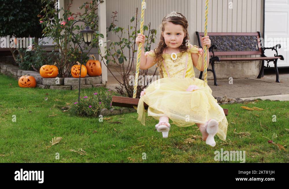 Little girl dressed as a princess swings in front yard Stock Video ...