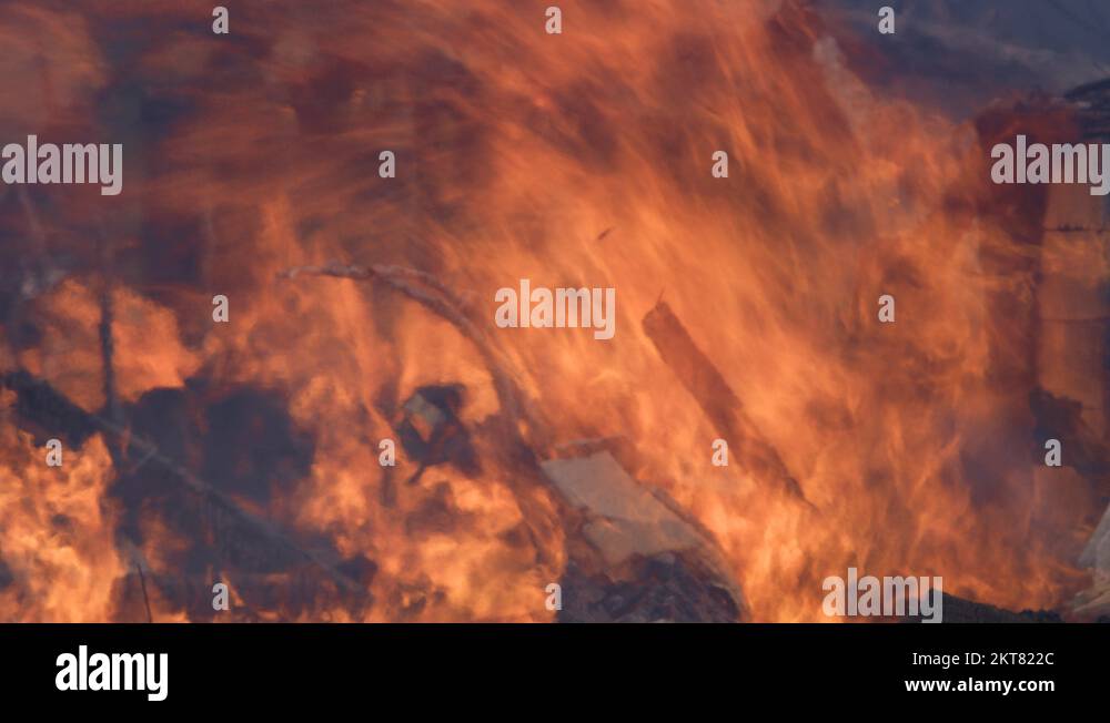 Flames burn amid the rubble of a house fire Stock Video Footage - Alamy