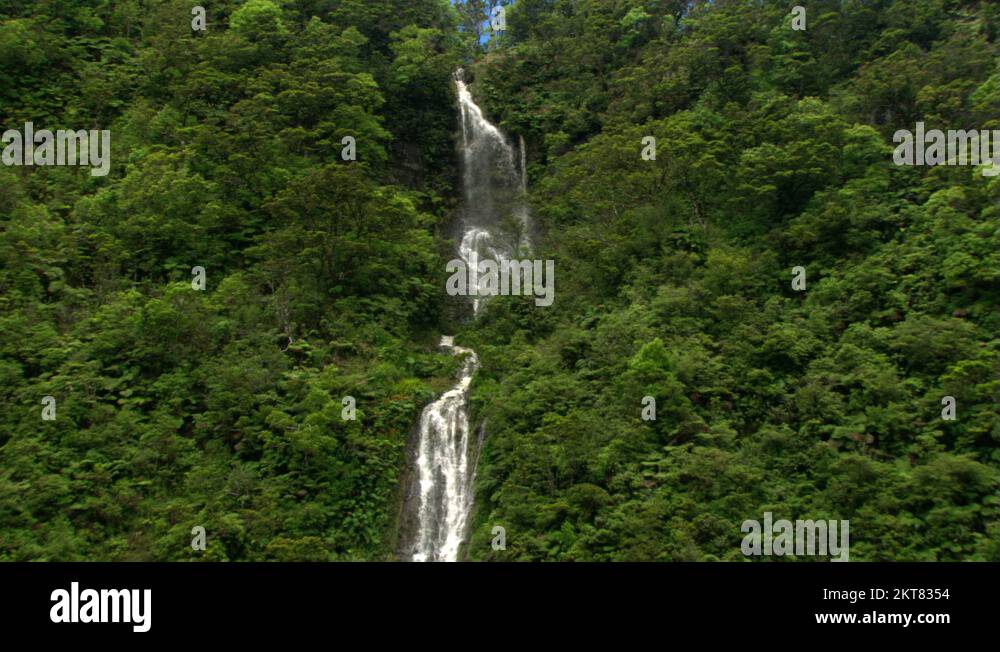 Long aerial view of waterfall descending cliff in Hawaii Stock Video ...